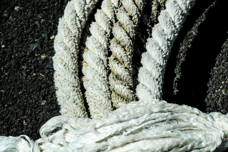 A Rope is Laying on the Ground with a Black Background Stock Image ...