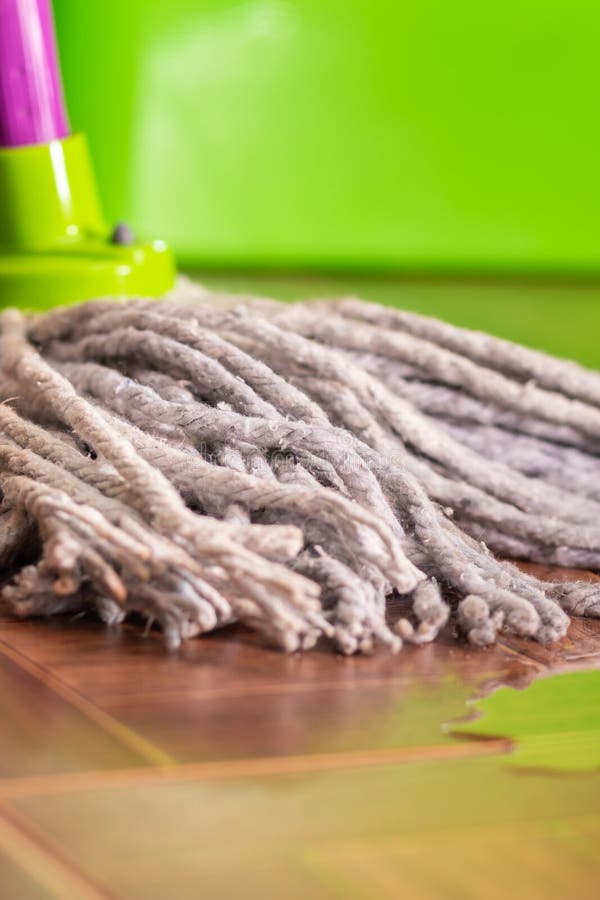 Rope Mop on the Tile Floor and a Puddle of Water. Stock Image - Image ...
