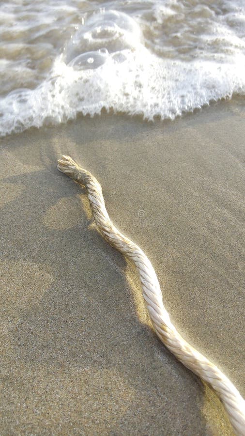 Rope with Ocean Waves on the Beach Stock Photo - Image of abstract ...