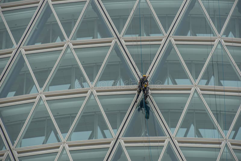 A Rope Operator with a Harness, Lowering Himself Onto the Facade of a ...