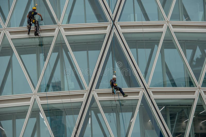 A Rope Operator with a Harness, Lowering Himself Onto the Facade of a ...