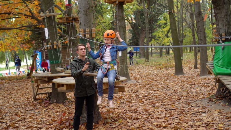 Rope Park. a Young Instructor Helps a Little Girl Stock Footage - Video ...