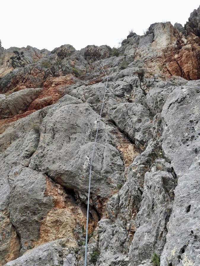 A Rope on the Rock for Climbing Stock Image - Image of river, mountains ...