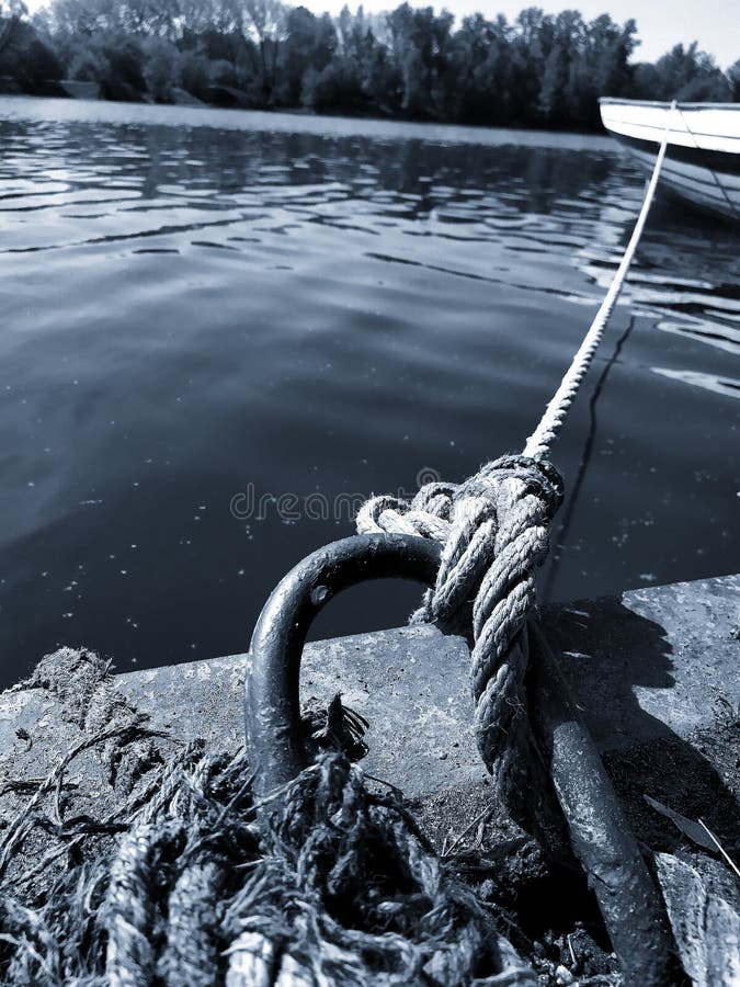 A Rope with a Sea Knot on the Pier Holds the Boat Stock Image - Image ...