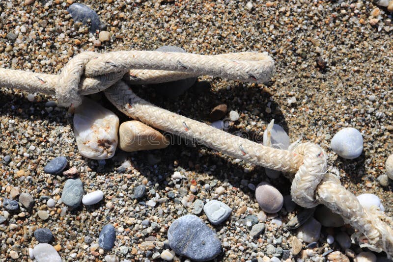 Rope with stone on sand stock photo. Image of rope, outdoor - 181510526