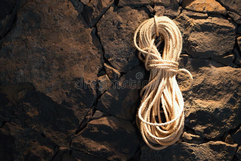 Rope on a stone wall stock photo. Image of folded, roll - 122480962