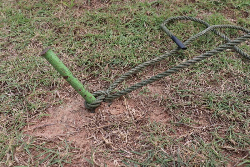 Rope Tied with Steel Pins on the Lawn Stock Image - Image of rope ...