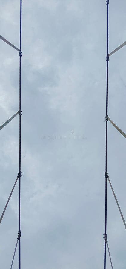 Ropes from a Suspension Bridge Against the Backdrop of the Sky in West ...