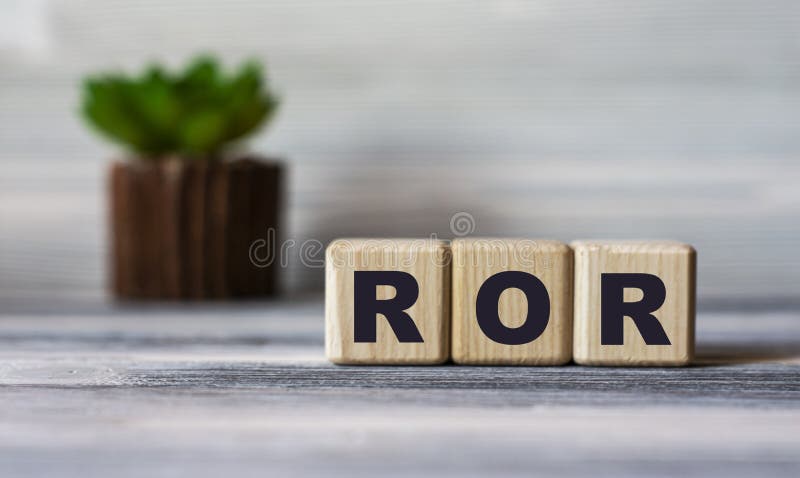 ROR - Word on Wooden Cubes Against the Background of a Light Board with ...