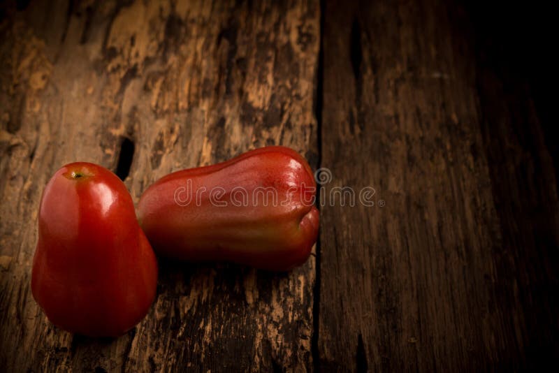 Rose apple on wood. dark stock image. Image of rose - 105479289