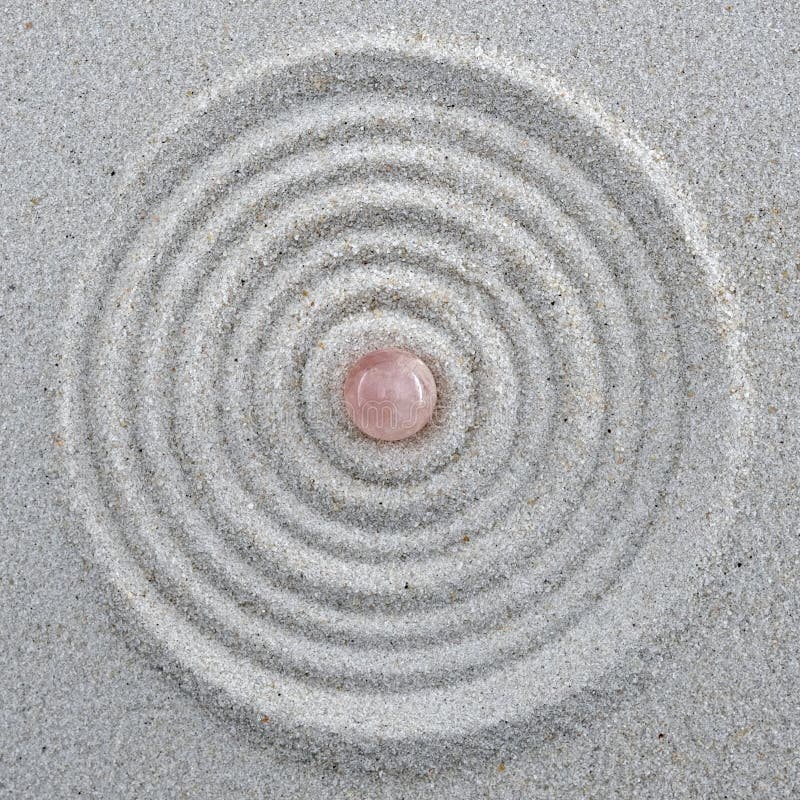 Rose Quartz Sphere in the Middle of Circles Drawn in Sand Stock Image ...