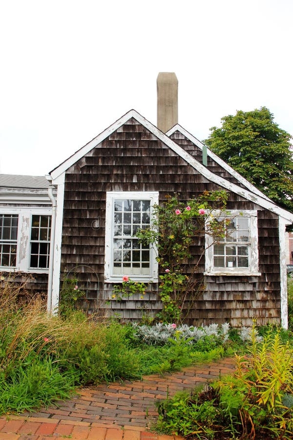 Brick Cape Cod Home stock photo. Image of fence, garden - 24323732
