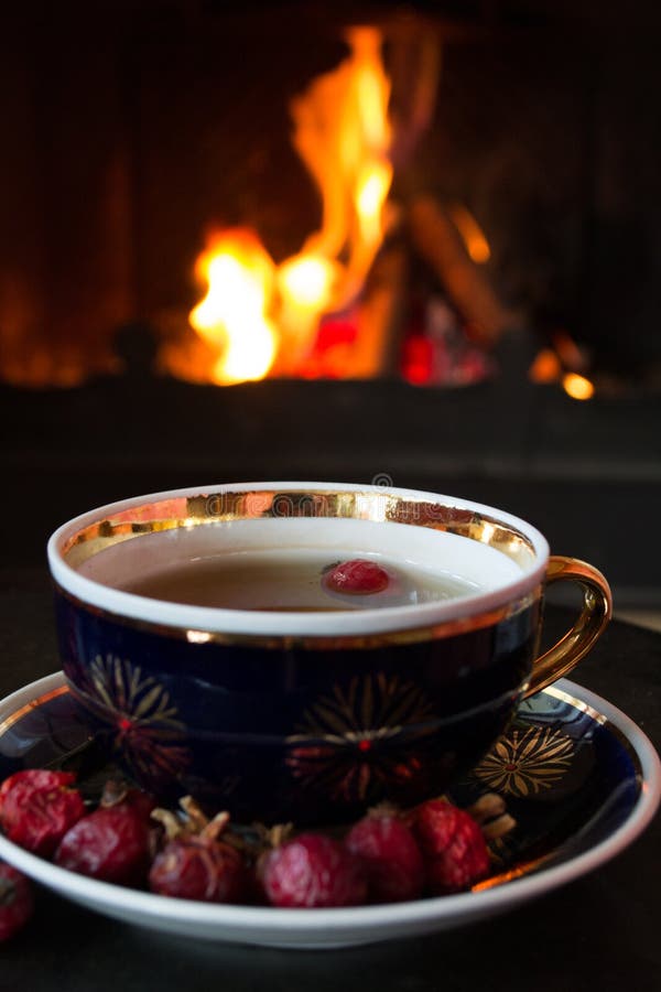 Rosehip Tea in Front of Roaring Fire in a Fire Place Stock Photo ...