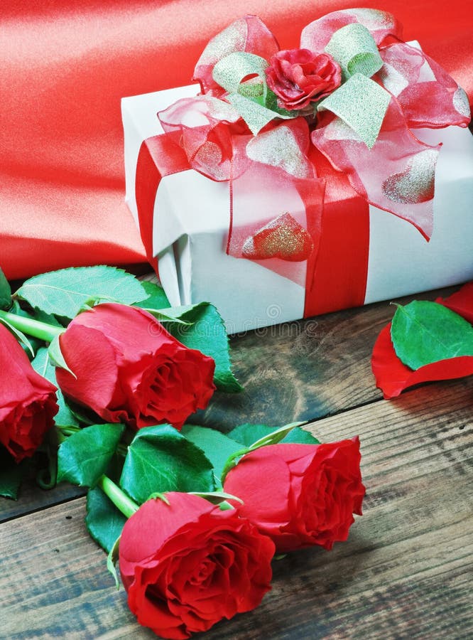 Roses and Holiday Gift on a Wooden Table Stock Photo - Image of floral ...