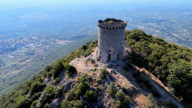 Rotating Camera Capturing an Old Stone Tower Atop a Mountain with ...