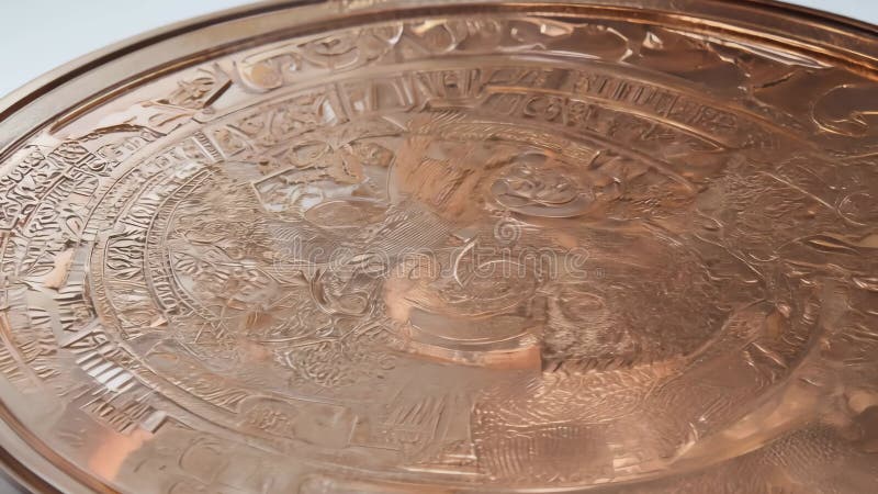 Rotating Top View of a Detailed Copper Surface with Ornate Engravings ...