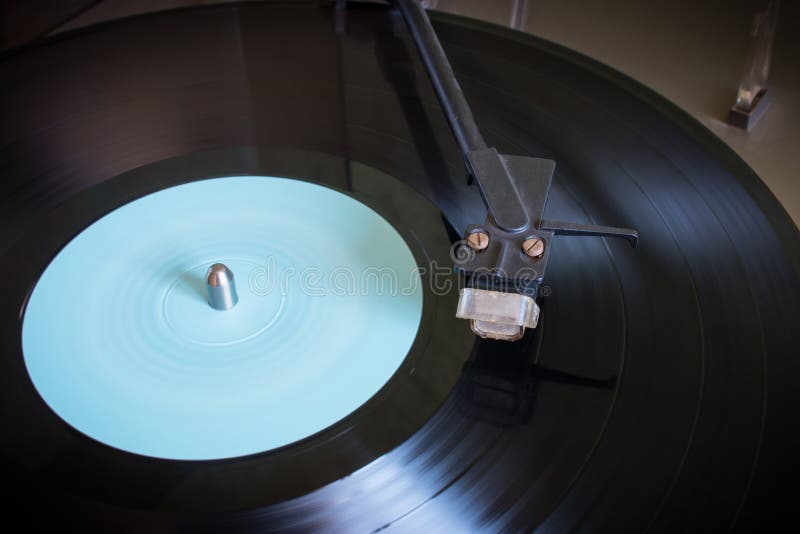 Rotating Vinyl Record with Blue Label on a Turntable Close-up Stock ...
