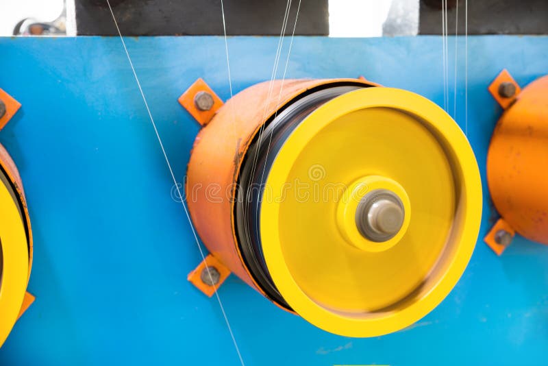 A Rotating Wheel Rewinds a Thin Silver Wire. Stock Photo - Image of ...