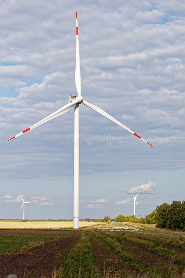 Rotating Wind Turbines at a Distance in the Field Against the Cloudy ...