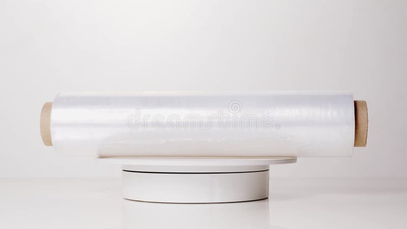 Rotation. a Roll of Packaging Stretch Film on a White Table Stock ...