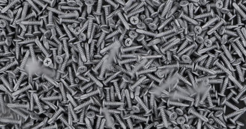 Rotation. Screws with Drills Falling on a Bunch of Screws with Drills ...