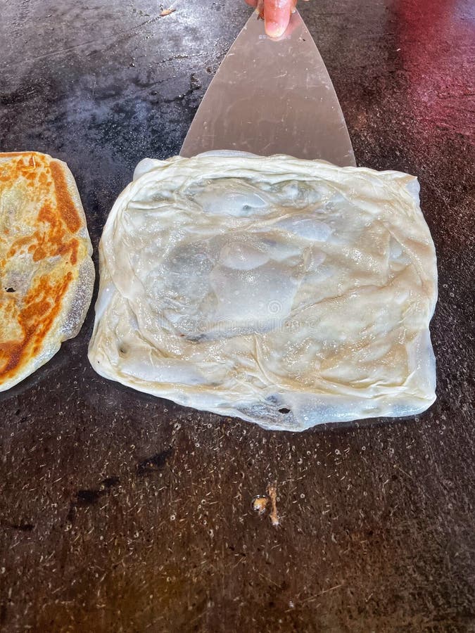 Roti canai in making. stock photo. Image of food, gourmet - 308768958