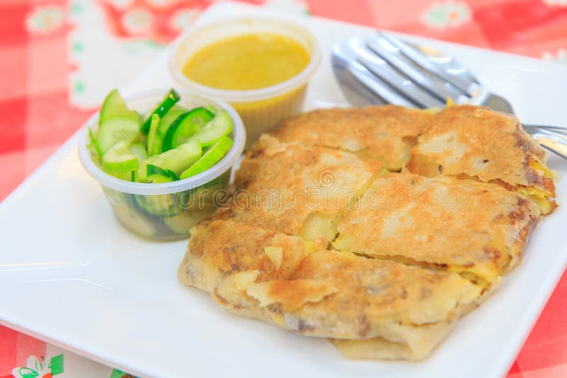 Roti Mataba and Sauce Cup in White Plate with Hot Tea Glass Stock Photo ...