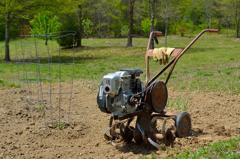 Rototiller in the garden stock photo. Image of machine - 40018288