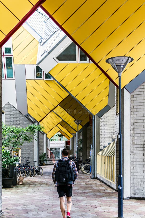 Man Walking through Repeating Cube Pattern of Cube Houses Editorial ...