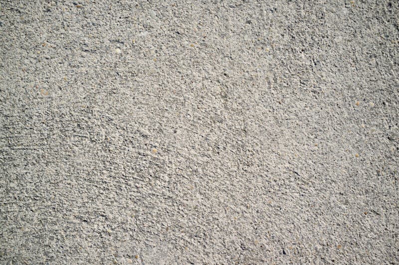 Rough Concrete Wall Texture with Small, Grey Rocks Embedded in Surface ...