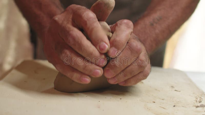 Rough Hands of Artisan Potter Crumple and Roll Clay on Table, Front ...