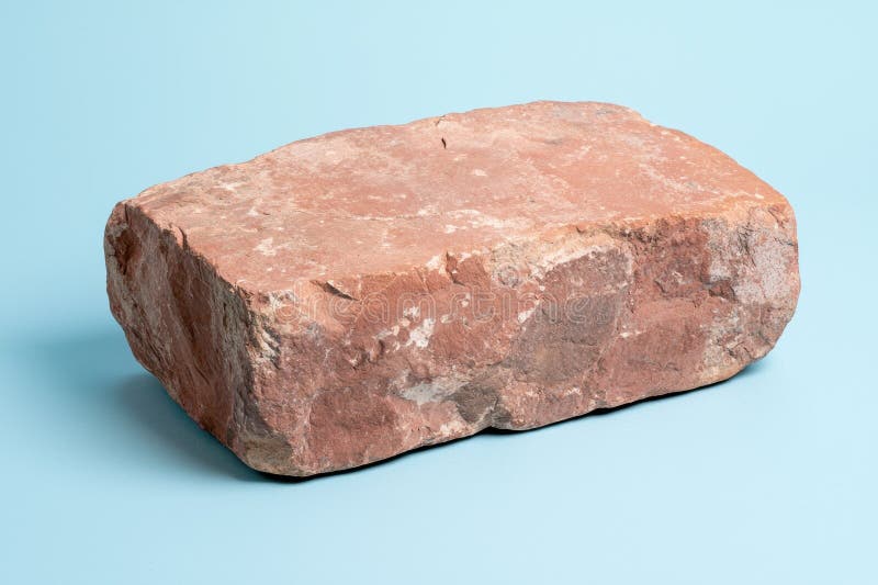 Rough Reddish-brown Stone Block on a Light Blue Background Stock ...