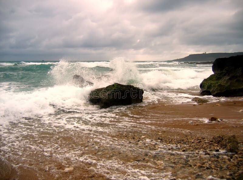 Sea trough the beach rocks stock image. Image of looking - 127237945