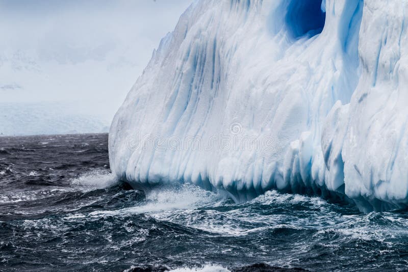 Rough Seas Smash Up on Sides of Floating Iceberg in Antarctica Stock ...
