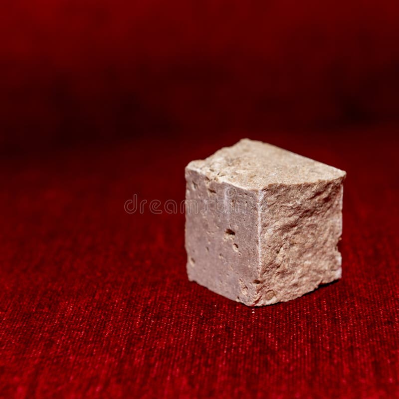 Rough Stone Cube Isolated on Blurred Red Background Stock Photo - Image ...