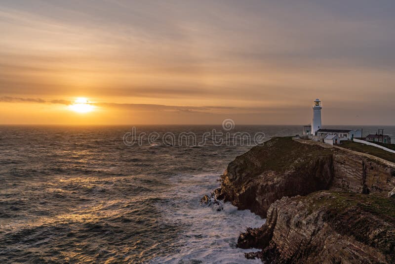 Rough Weather Off the Lighthouse at Sunset Isle of Anglesey North Wales ...