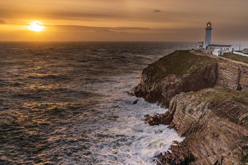 Rough Weather Off the Lighthouse at Sunset Isle of Anglesey North Wales ...