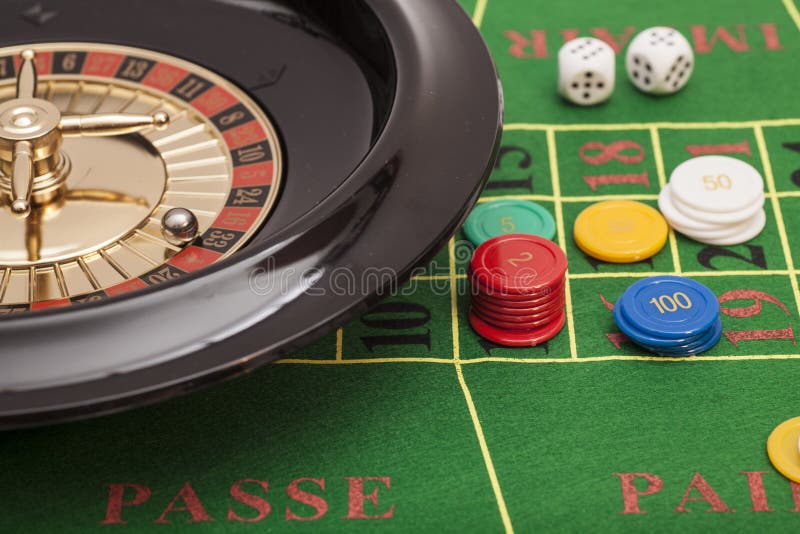 Roulette in Casino ,chips and Dices Stacking on a Green Felt Stock ...