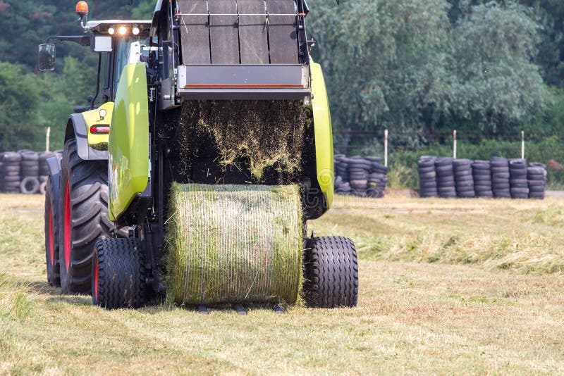 Round baler stock photo. Image of fall, mesh, hayfield - 57086256