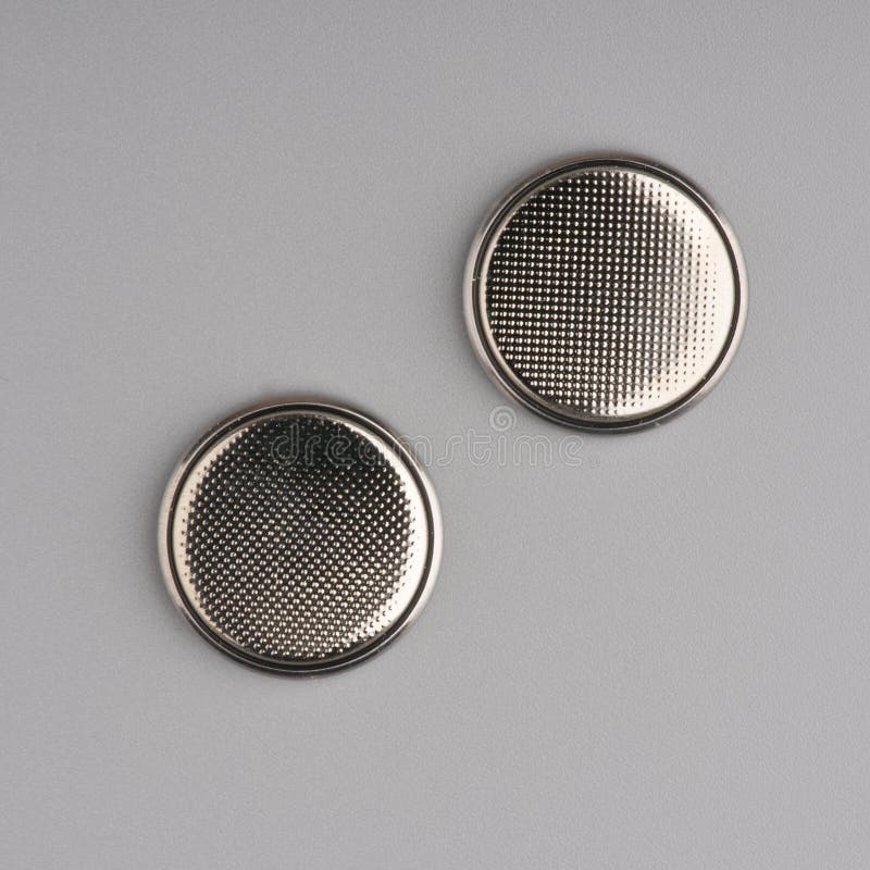 Round Batteries on a Gray Background. Closeup Stock Photo - Image of ...
