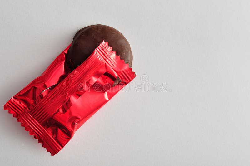 Round Biscuits Covered in Chocolate with a Red Wrapper Stock Image ...