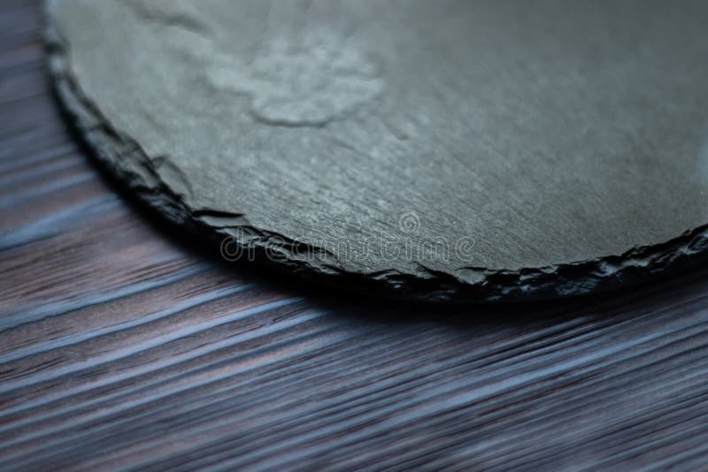 Round Black Slate Board on Wooden Table Stock Photo - Image of empty ...