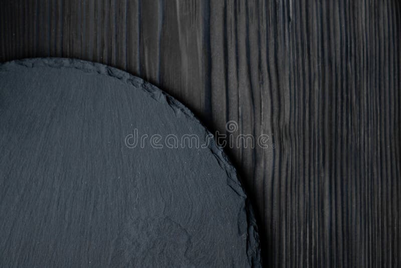 Round Black Slate Board on Wooden Table Stock Photo - Image of empty ...