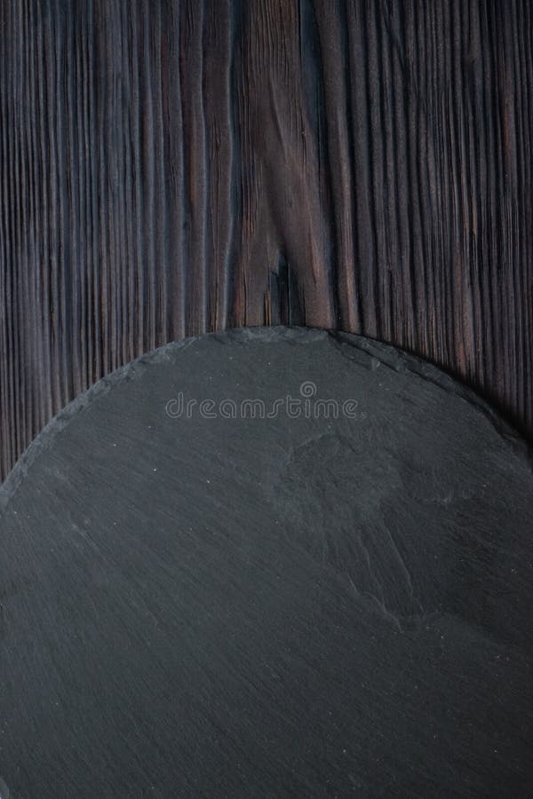Round Black Slate Board on Wooden Table Stock Image - Image of cutting ...