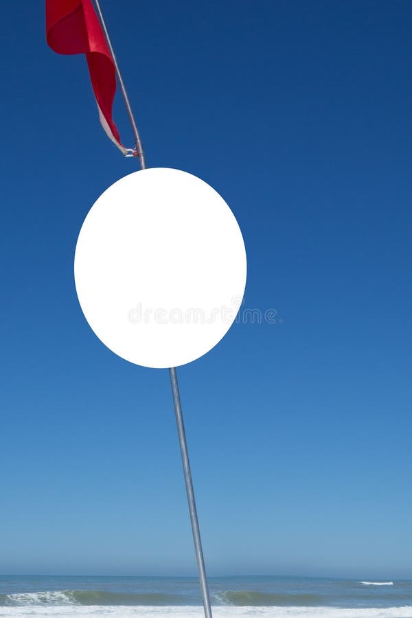 Round Blank Sign in Blue Sky with Red Flag on Beach Stock Image - Image ...