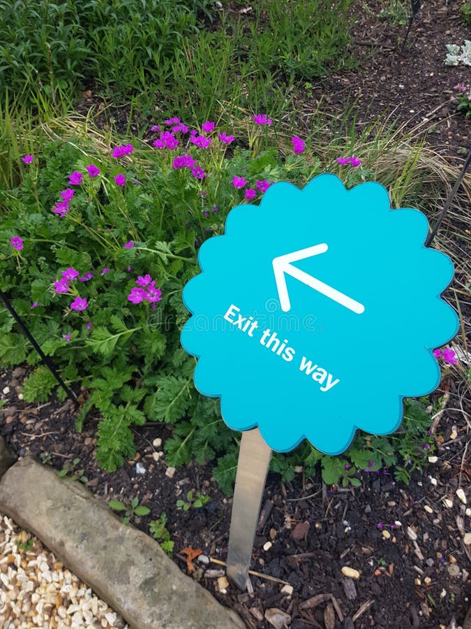 Round Blue Exit this Way Sign. Stock Photo - Image of garden, green ...