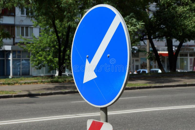 Blue Road Sign With White Arrow Stock Photo - Image of round, traffic ...
