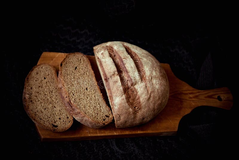 Round Bread, Lying on a Brown, Wooden Board Stock Photo - Image of ...