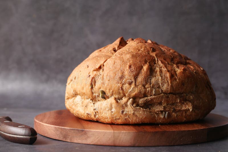 Round Brown Baked Bread on Chopping Board Stock Image - Image of bread ...