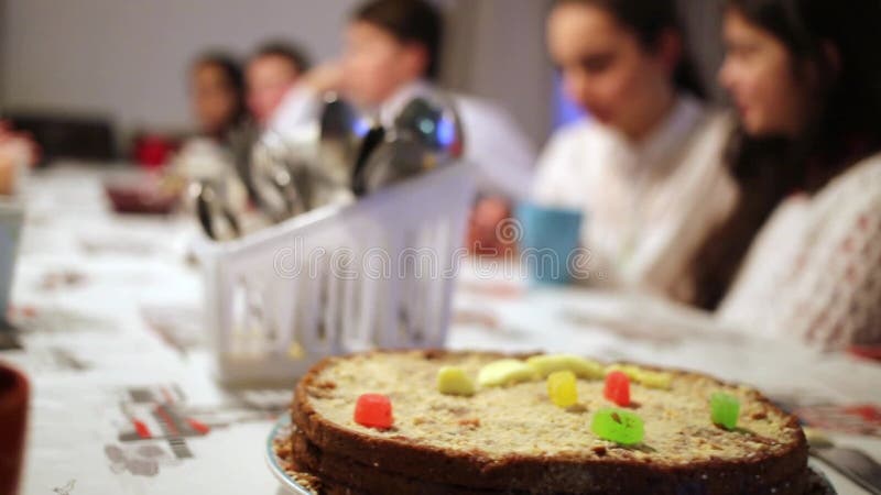 Round Cake on Table and Group of Children at Tea Stock Footage - Video ...